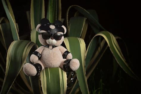 Premium Photo BDSM Teddy Bear In Leather Straps And Mask Accessory For Sex Games On A Prickly