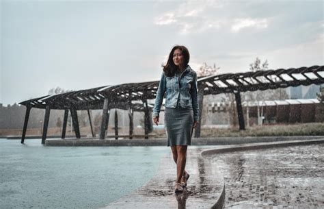 Premium Photo Full Length Portrait Of Woman Standing By Pond On Rainy Day