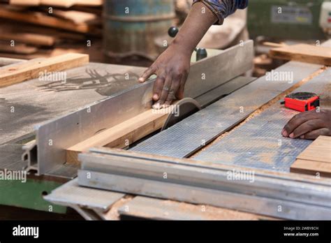 African Man Working With A Saw Blade Wood Working Machine In The