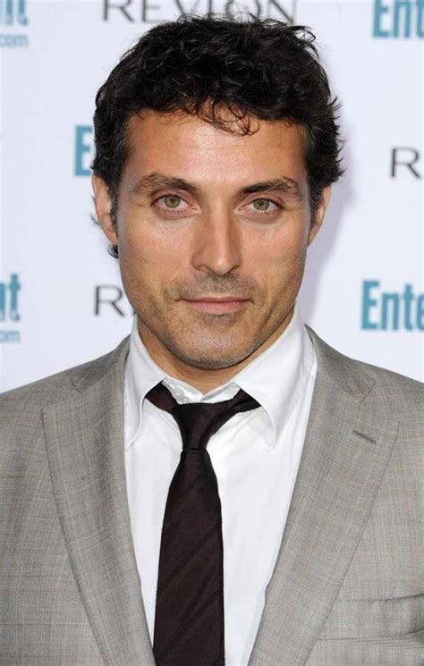 Download Caption Elegant Rufus Sewell In A Gray Suit And Black Tie