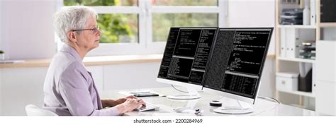 Programmer Woman Coding On Multiple Computer Stock Photo 2200284969