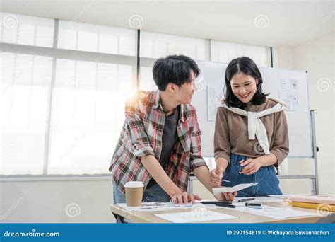 A Smart And Handsome Young Asian Male Website Developer Is Talking And Planning A New Project