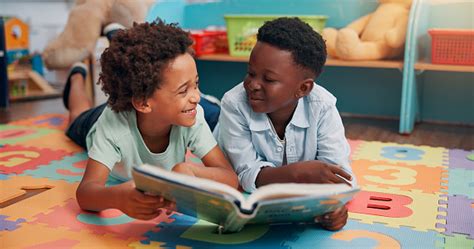 어린이 소년 교실에서 바닥에서 책을 읽고 학원에서 함께 교육을 위해 배웁니다 초등학교에서 장학금을 받기 위해 문해력 발달 또는 독서와 함께 매트 위에서 행복하고 행복한