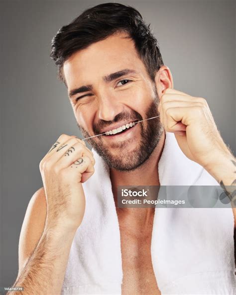 치실 치아 스튜디오에서 치과 건강 루틴으로 입을 닦는 남자의 초상화 건강 관리 치과 및 회색 배경으로 격리된 구강 관리 건강 및 위생을 위한 모델 치실 25 29세에 대한