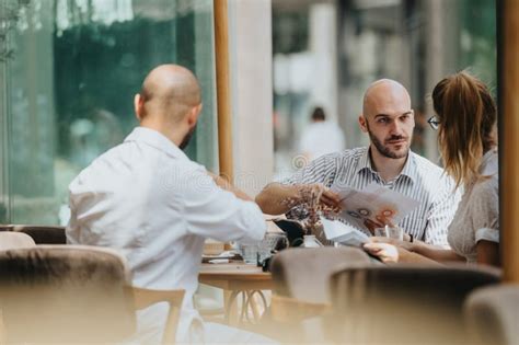 Team In Business Meeting Discussing Strategy And Brainstorming In A Modern Office Setting Stock