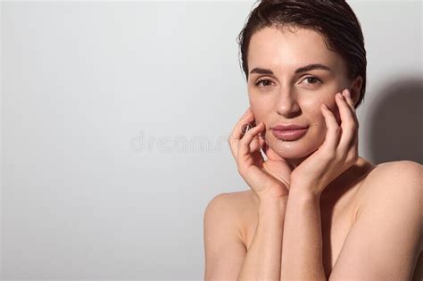 Natural Beauty Woman With Healthy Fresh Skin Putting Her Hands On Her Face Looking At Camera