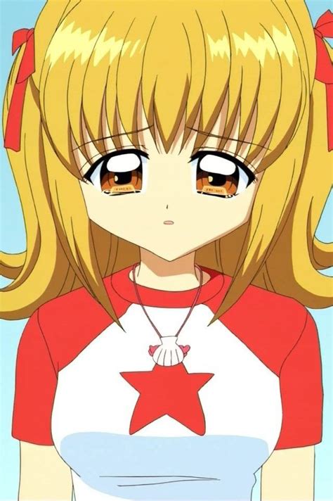 An Anime Girl With Blonde Hair And Big Eyes Wearing A Red Star T Shirt