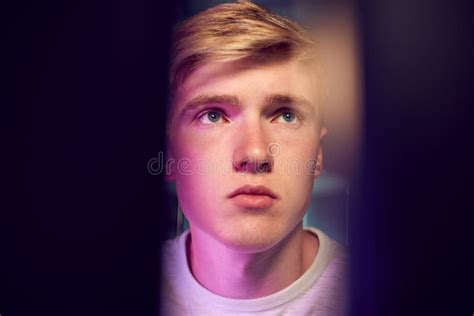 Male Teenage Hacker Sitting Between Computer Screens Bypassing Cyber Security Stock Image
