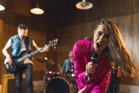 Excited Caucasian Woman Vocalist Sings With Her Mouth Wide Open