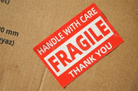A Cardboard Box Marked With A Caution Label For Fragile Goods Handling