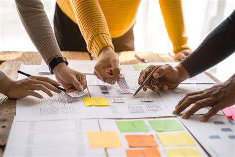 Ux Developer And Ui Designer Brainstorming About Mobile App Interface Wireframe Design With