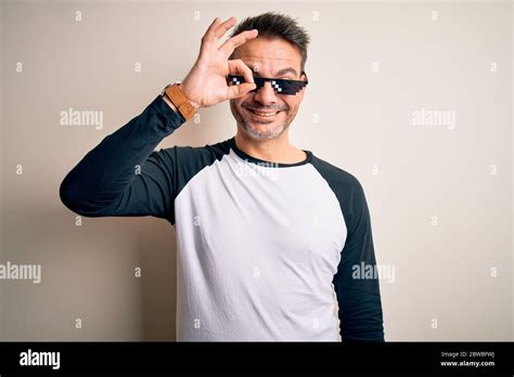 Young Handsome Man Wearing Funny Thug Life Sunglasses Meme Over White