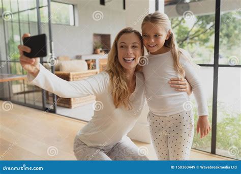 Mother Taking Selfie With Her Daughter On Mobile Phone Stock Image
