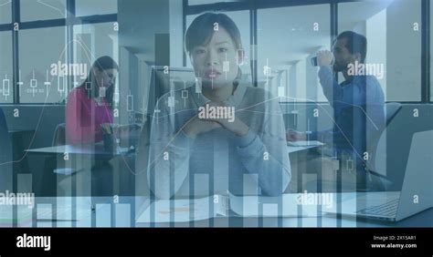 Statistical Data Processing Over Asian Businesswoman Talking Looking At The Camera At Office