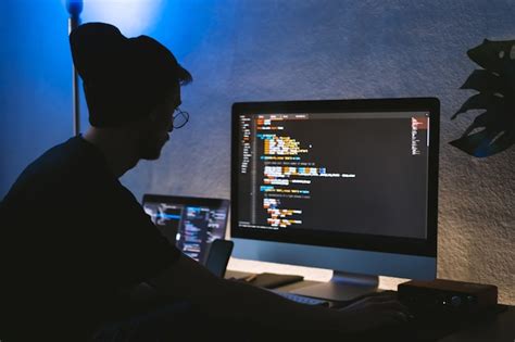 Premium Photo Young Man Mobile Developer Writes Program Code On A