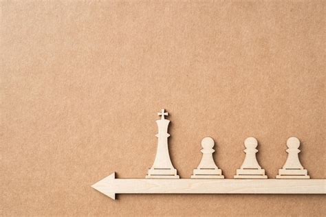 Premium Photo Chess Pieces And Arrow Against Brown Background