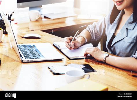 Learning Note Taking Planning Female Employee Holding A Pen To Write A Notebook And Using A
