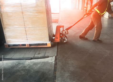 Workers Unloading Packaging Boxes On Pallets To The Cargo Container Trucks Loading Dock