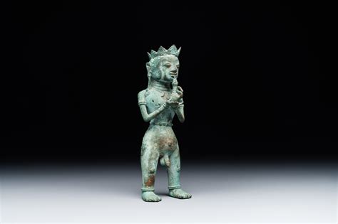A Fine Indonesian Bronze Sculpture Of A Naked Man Offering A