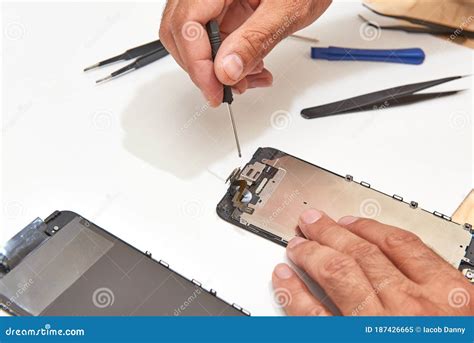 Technician Hand Repairing Cellphone Process Of Mobile Phone Repair On White Background