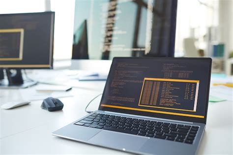 Premium Photo Background Image Of Open Laptop With Code On Screen At Desk In It Developers