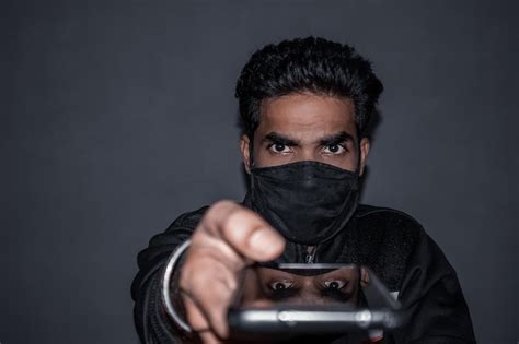 Premium Photo Photo Of A Hacker Giving Smartphone And Saying Hacker Never Gives
