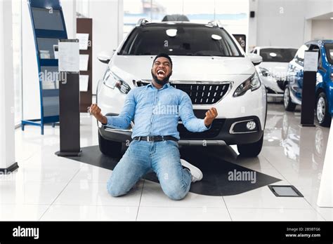 Excited Man Shouting Shaking Fists Buying New Car In Dealership Stock