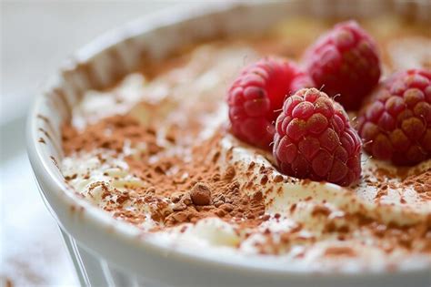 Tiramisu With A Raspberry Garnish Premium Ai Generated Image