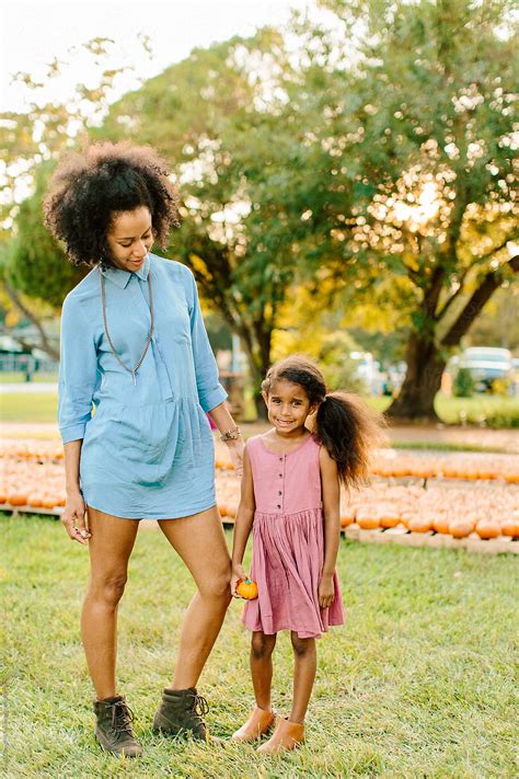 Portrait Of A Mother And Daughter At A Pumpkin Patch By Stocksy