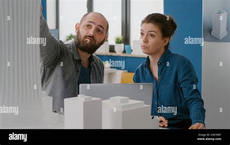 Workmates Designing Building Model And Maquette On Laptop In Architectural Office Team Of