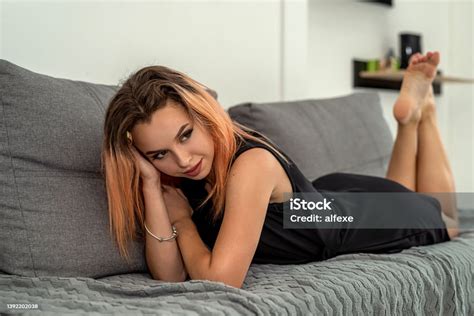 검은 옷을 입고 방에있는 소파에 아름다운 미소를 가진 젊은 여성의 초상화 귀여운에 대한 스톡 사진 및 기타 이미지 귀여운 긍정적인 감정 표현 목가적인 Istock