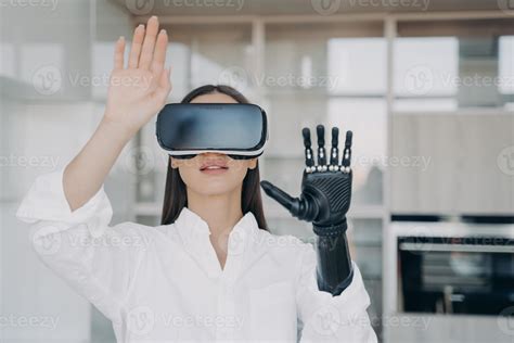 Female In Virtual Reality Glasses Training To Use Bionic Prosthetic Arm