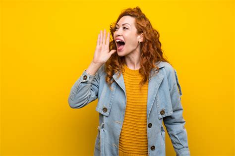 빨간 머리 여자 위에 고립 된 노란색 배경 외침 와 입 넓은 열린 노랑에 대한 스톡 사진 및 기타 이미지 노랑 말하기