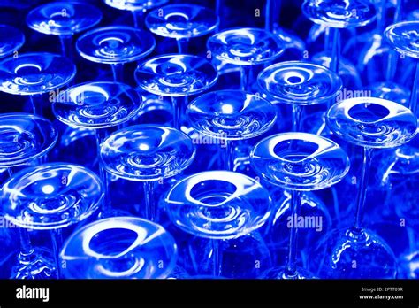 The Glass Bottoms Of Several Rows Of Upside Down Wine Glasses In A Bar