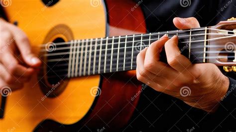 A Person Skillfully Plays An Acoustic Guitar Fingers Gracefully