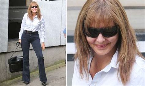 Carol Vorderman Wears Skin Tight Denim Flares And Black Sunglasses
