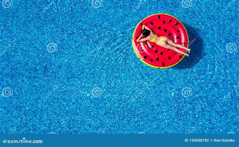 Aerial View Of Woman In Bikini Lying On A Floating Mattress In Swimming Pool In Swimming Pool