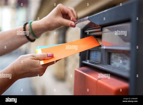 Sending Letters By Mail Woman Inserting Envelope Into Public Mailbox At Post Office Female
