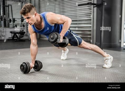 Muscular Man Doing Push Up With Dumbbells Stock Photo Alamy