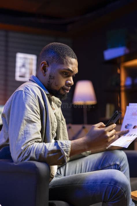 Black Remote Worker Doing Math Calculations Using Financial Graphs On Papers Stock Image Image