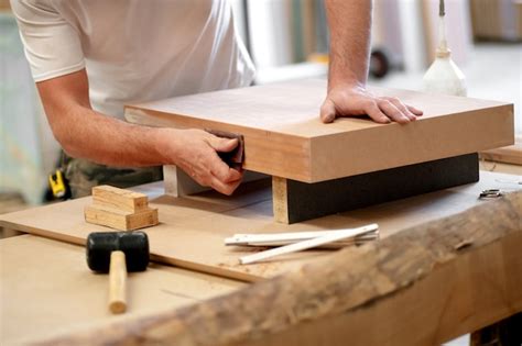 Premium Photo Carpenter Sanding A Wooden Block Manually