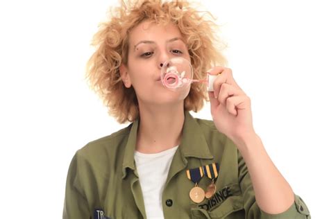 Premium Photo Young Female Model Blowing Soap Bubbles