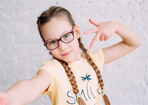 Premium Photo Cute Tweens Girl In Yellow T Shirt With Funny Pigtails