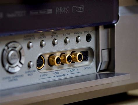 Gray Sony Audio Component On White Table Connecting Optical Cable To Tv
