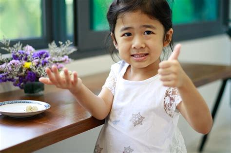Premium Photo Portrait Of Cute Girl At Table