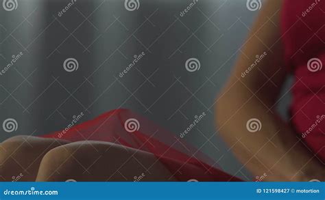 Attractive Confident Girl Sitting With Crossed Legs On Sofa Flirting With Man Stock Video