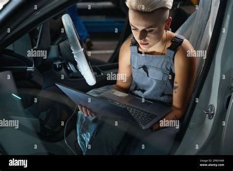 Auto Repairwoman Conducts Computer Diagnostics Of Car With A Laptop Stock Photo Alamy