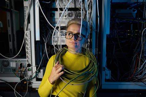 Overworked Data Center Engineer Using Keyboard On Supercomputer Server