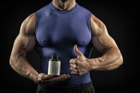 Premium Photo Handsome Sexy Athlete Man With Muscular Body Holds Steroid Jar