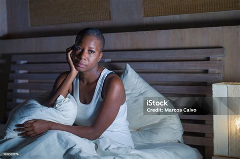 젊은 슬 프 고 우울 흑인 아프리카 미국 여자 침대 잠 못 드는 늦은 밤 걱정이 고 불안 우울증 문제 및 불면증 수 면 장애를 겪고 절망 느낌에 걱정하는에 대한 스톡 사진